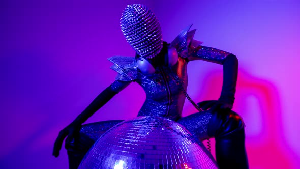 Female Dancer with Spiky Mask Against Colourful Background, Stock Footage