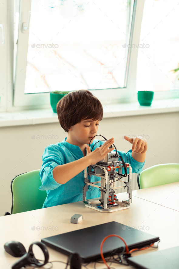 Concentrated pupil buildinig his new school project Stock Photo by ...
