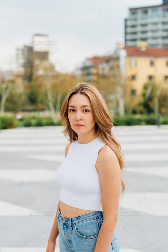 Young serious and dreamy woman outdoor looking camera posing modelling ...