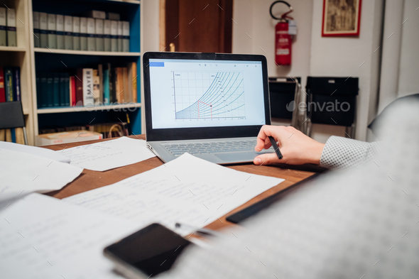 Back view young man indoors office using computer Stock Photo by peus80