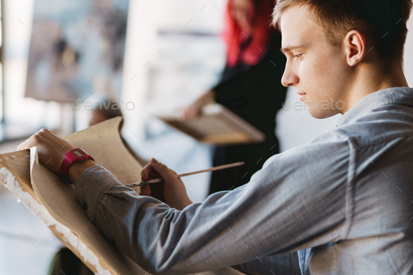 Young white students drawing during class in art school Stock Photo by ...