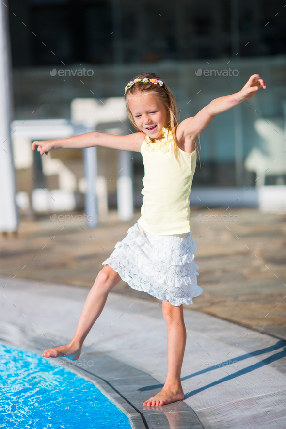 Little girl having fun with a splash near swimming pool Stock Photo by ...
