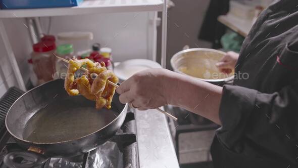 Peru Latin senior chef cooking Picarones in professional small business ...