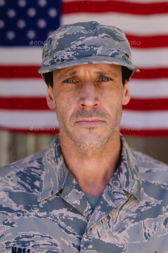 Portrait of confident army soldier wearing cap and camouflage uniform ...