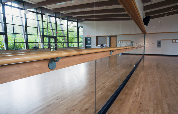 A dance or ballet studio,with a sprung wooden floor. Barre and wall ...