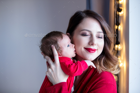 Redhead mother with new born child in red Stock Photo by Masson-Simon
