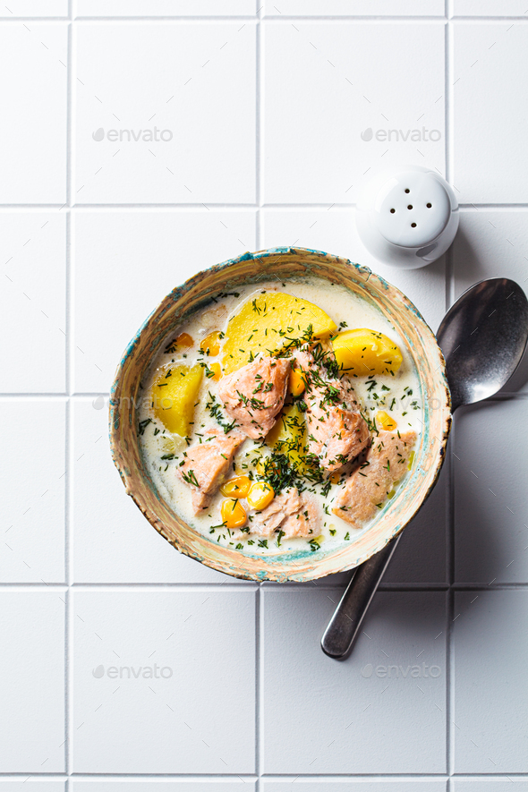 Norwegian fish soup with trout, potatoes and corn, white tile ...