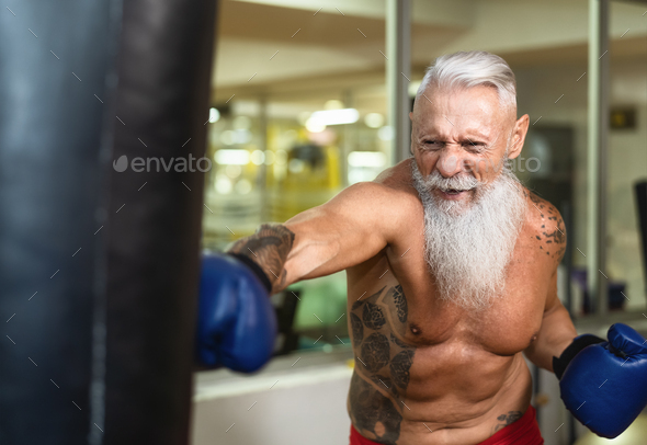 Senior man boxer training hard - Elderly male boxing in sport gym ...