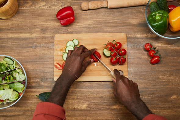 Cutting Fresh Vegetables Background Stock Photo by seventyfourimages