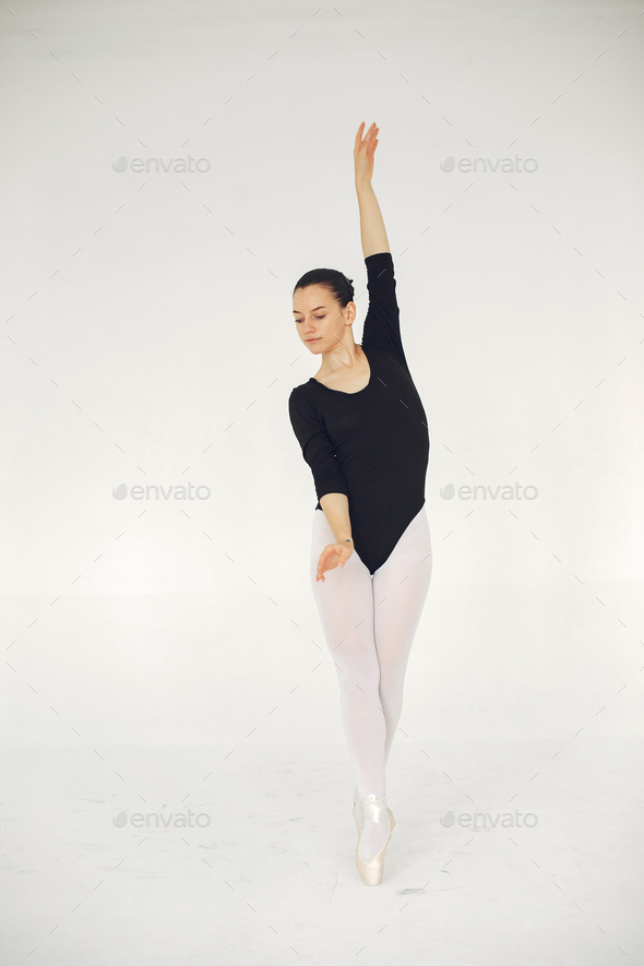 Ballerina posing in front of white background Stock Photo by prostooleh