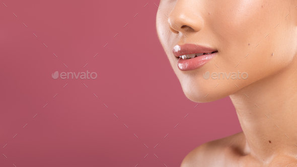 Unrecognizable woman showing her beautiful lips, copy space, side view ...