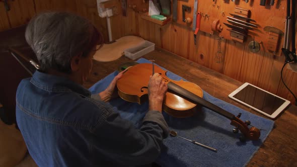 Female luthier at work in her workshop, Stock Footage | VideoHive