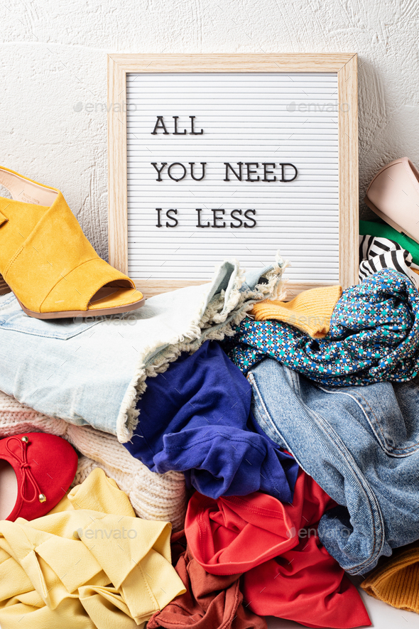 Fast fashion background with pile of cheap, low quality clothes ...