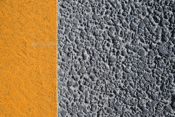 Road texture with yellow line. Road dark granular asphalt and bright ...