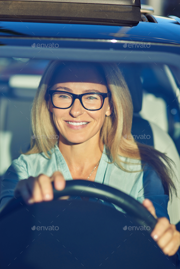 Cheerful beautiful mature woman or business lady wearing eyeglasses ...
