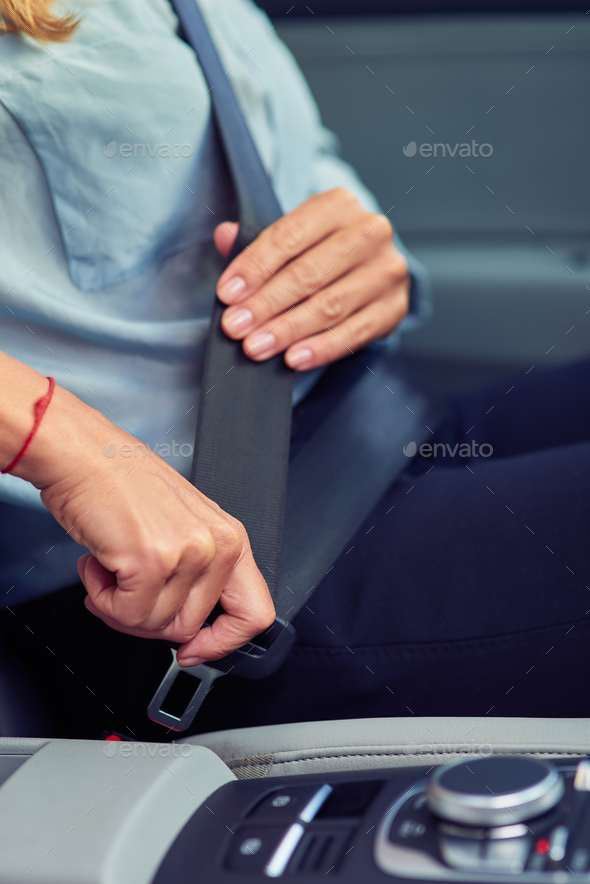 Driving safely. Cropped shot of a woman sitting behind steering wheel ...