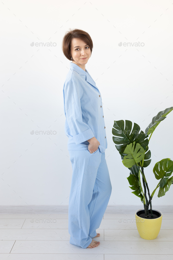 Young attractive woman dressed in beautiful colorful pajama posing as a ...