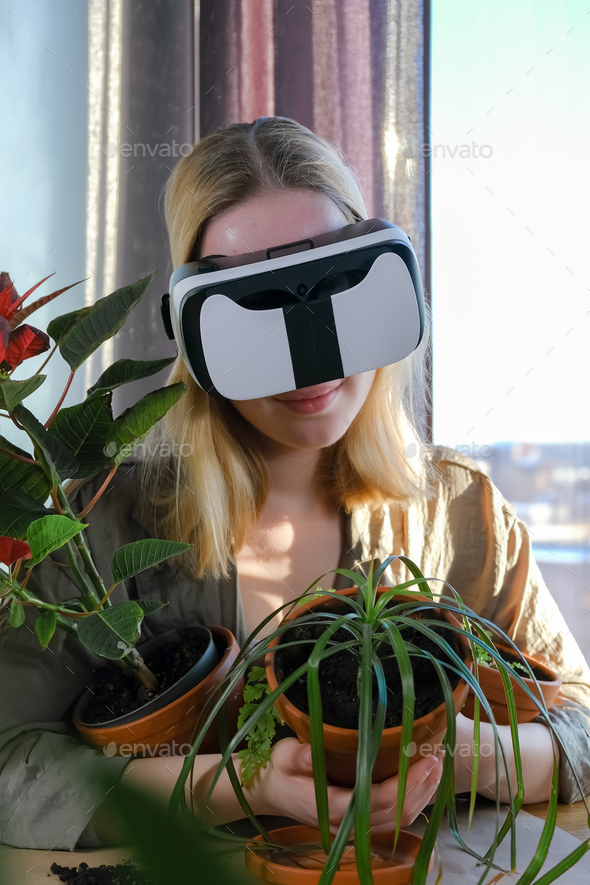 Gardening.Virtual world, metaverse.Girl planting flowers in immersive ...