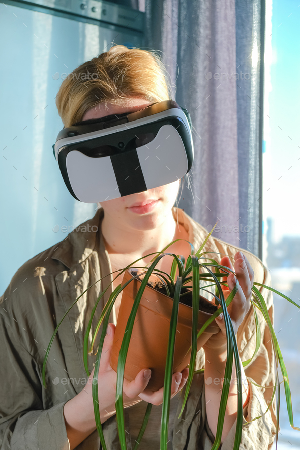 Gardening.Virtual world, metaverse.Girl planting flowers in immersive ...