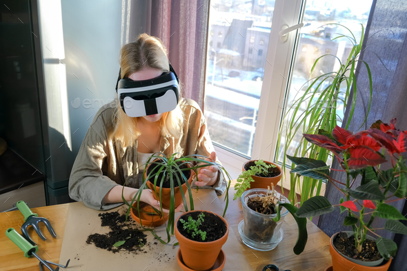 Gardening.Virtual world, metaverse.Girl planting flowers in immersive ...