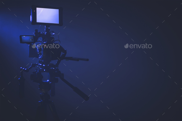 Modern Digital Cinema Camera with External Display Staying on a Tripod ...