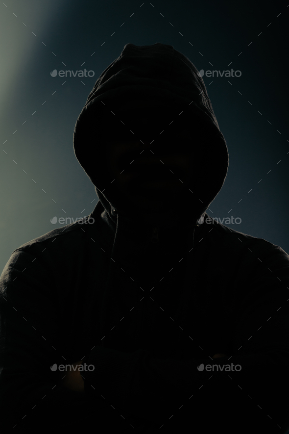 Mystery man with hidden face in a hood in the dark. Stock Photo by ...