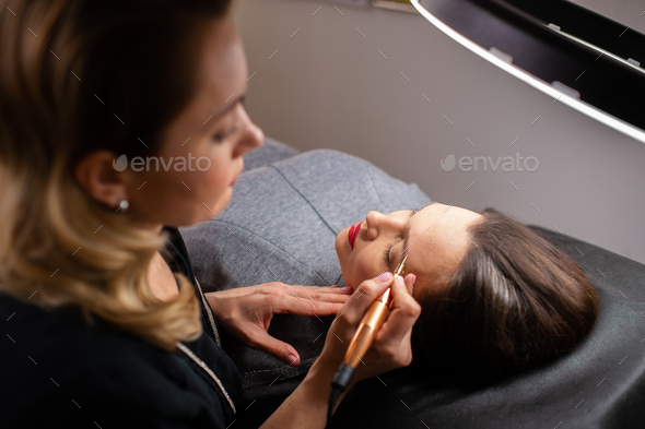 Eyebrows make up process. Make-up artist in beauty studio doing makeup ...