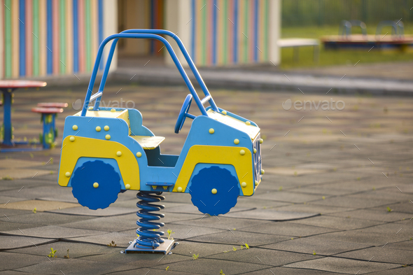 Kindergarten playground with bright toy car on spring. Children ...