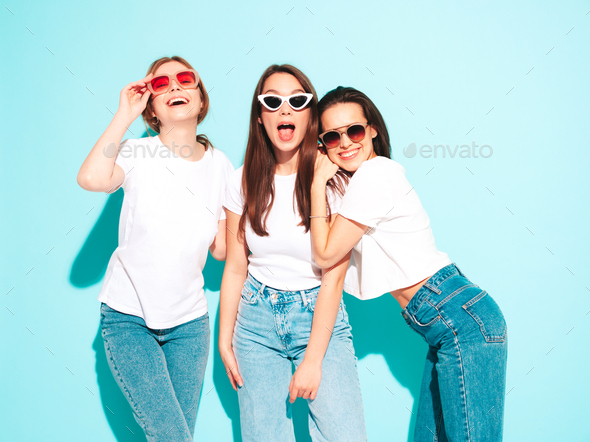 Three young beautiful women posing in studio Stock Photo by halayalex