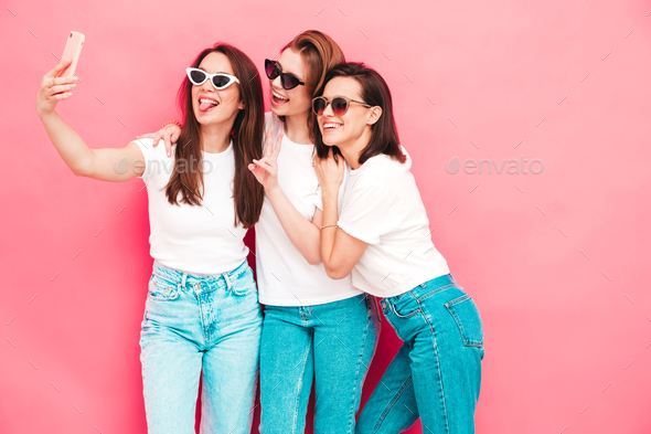 Three young beautiful women posing in studio Stock Photo by halayalex