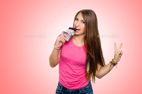 Beauty model woman eating dark chocolate. Beautiful Surprised young ...