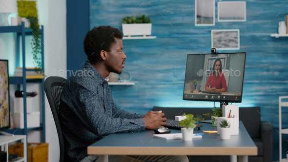 Remote worker working from home, talking on online conference internet ...