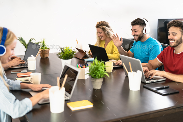 Young friends working together inside co-working creative space Stock ...
