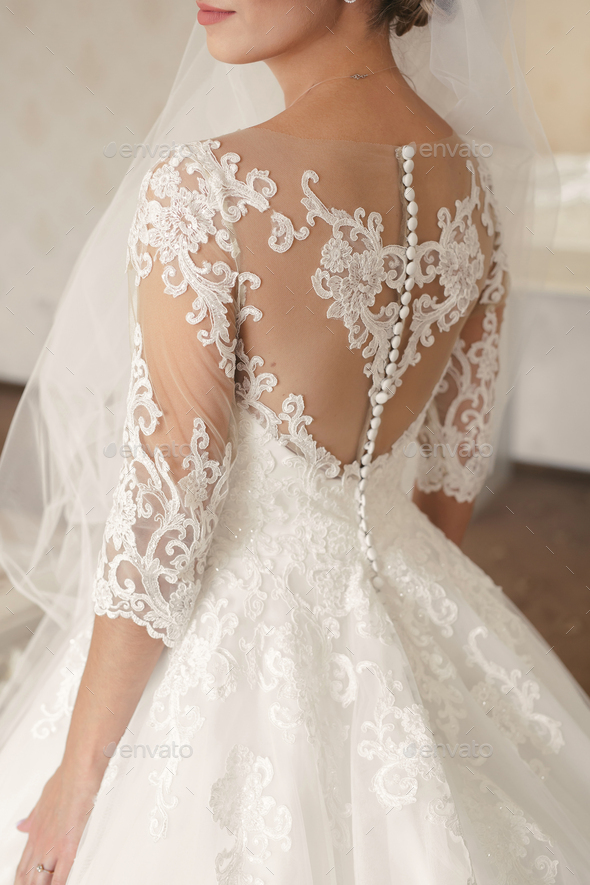 The bride with a beautiful dress that shows her bare back. Portrait of ...