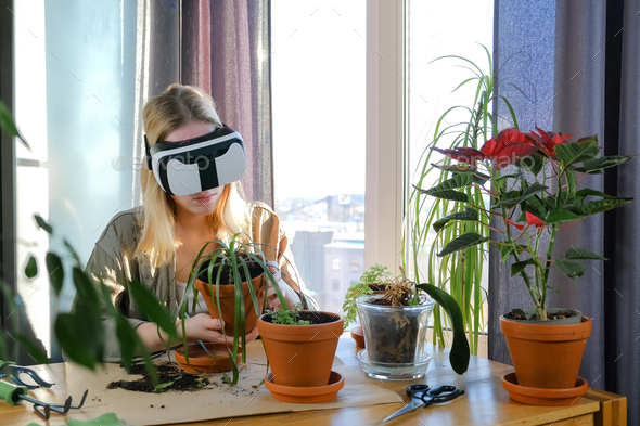 Gardening.Virtual world, metaverse.Girl planting flowers in immersive ...