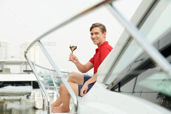 Man Celebrating Success on Yacht Stock Photo by DragonImages | PhotoDune