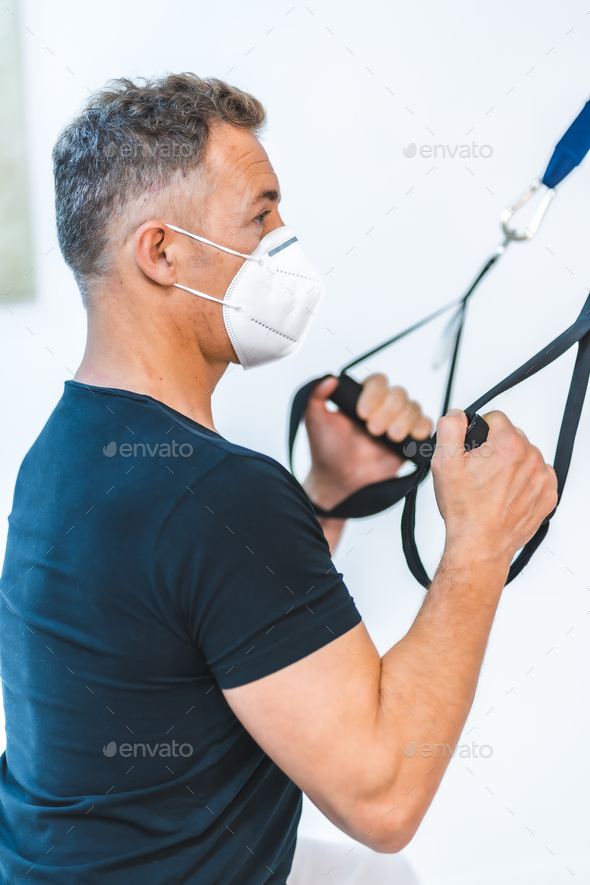 Patient with mask doing arm exercises Stock Photo by Unai82 | PhotoDune