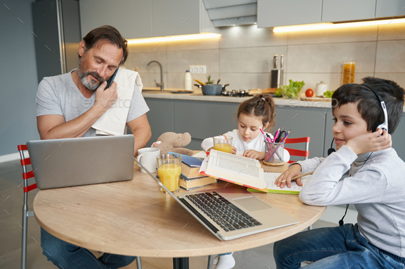 Father, son and daughter doing their business in kitchen Stock Photo by ...