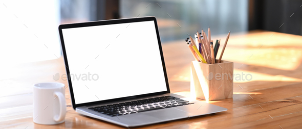 Horizontal photo of computer laptop with empty screen, pencil holder ...