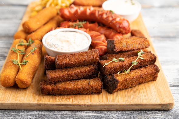 set of snacks: sausages, nuggets, cheese sticks, toast, cabbage salad ...