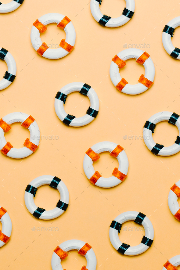 Pattern of life jackets over a pastel yellow background, minimalism ...