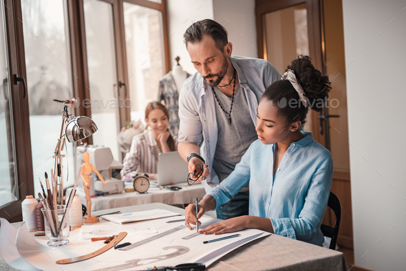 Help collegue with project. Group of three people at design studio ...