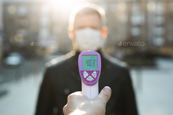 Operator check fever by digital thermometer visitor at information ...