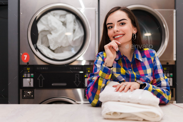 Satisfied laundry client against the background of dryers Stock Photo ...