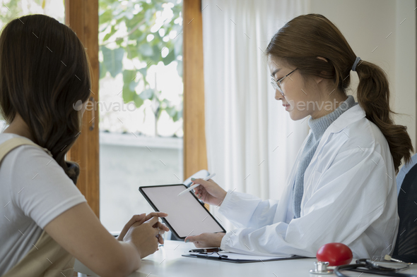 Doctor holding digital tablet explaining, discussing medical checkup ...