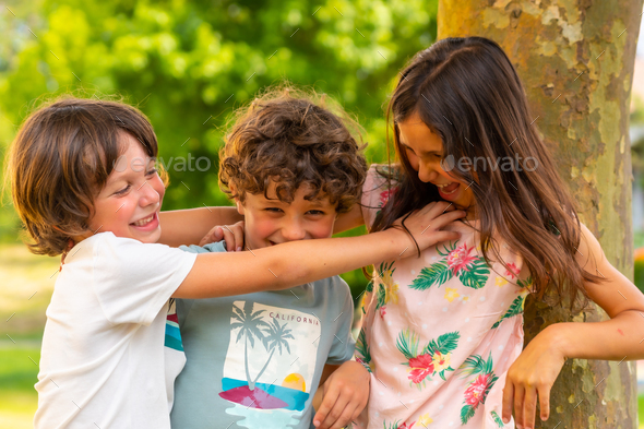 Lifestyle of three brothers smiling together in a park Stock Photo by ...