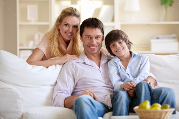 Smiling family at home Stock Photo by AboutImages | PhotoDune