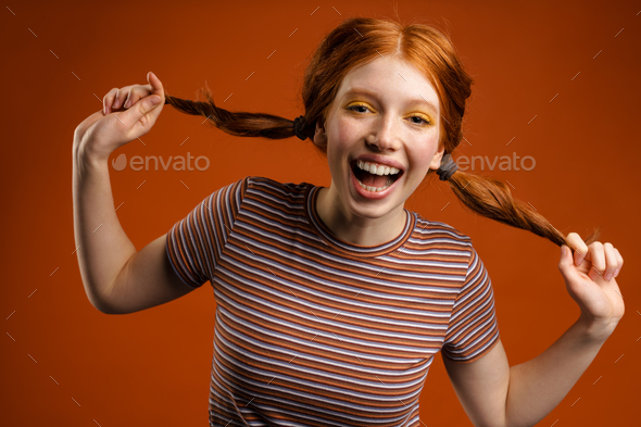 Ginger joyful woman making fun with her tails and laughing Stock Photo ...