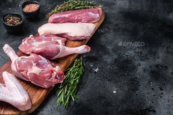 Raw duck meat ready to cook, breast fillet, legs, wings. Black ...