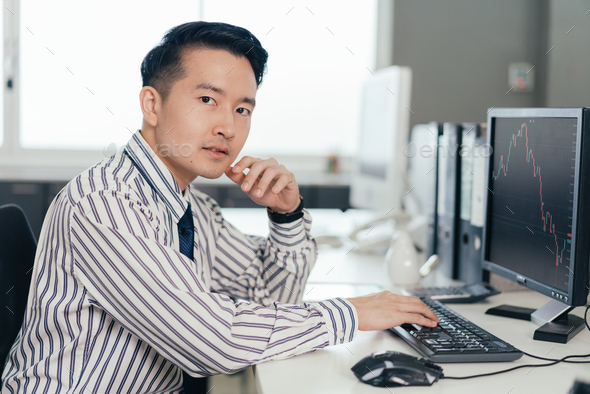 Asian male trader analysing stock market indicator Stock Photo by ...